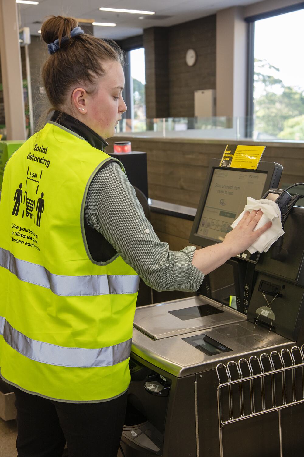 Digital Photograph - Staff Member Sanitising Self-Checkout Touchscreen ...
